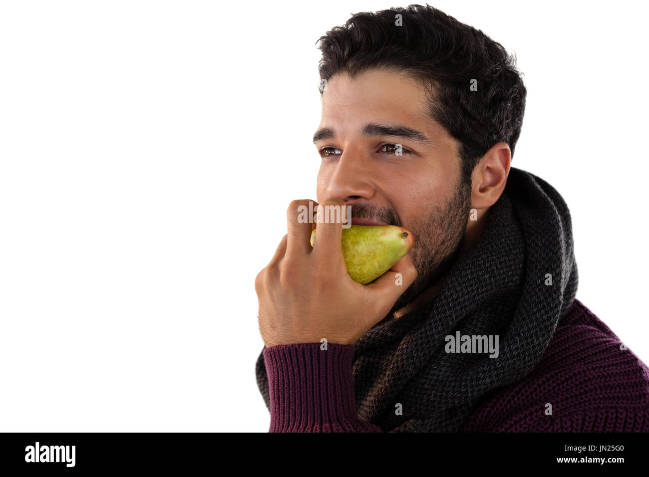 Close-up of man eating pears against white background Stock Photo - Alamy