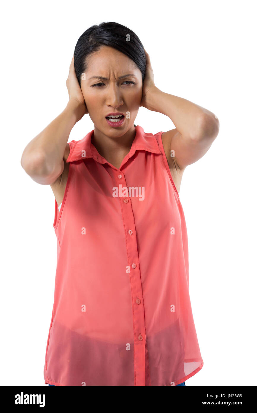 Woman covering her ears against white background Stock Photo - Alamy