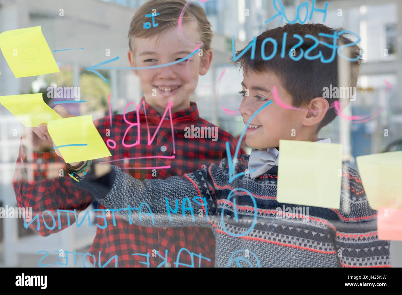 Kids as business executives discussing over whiteboard in office Stock ...