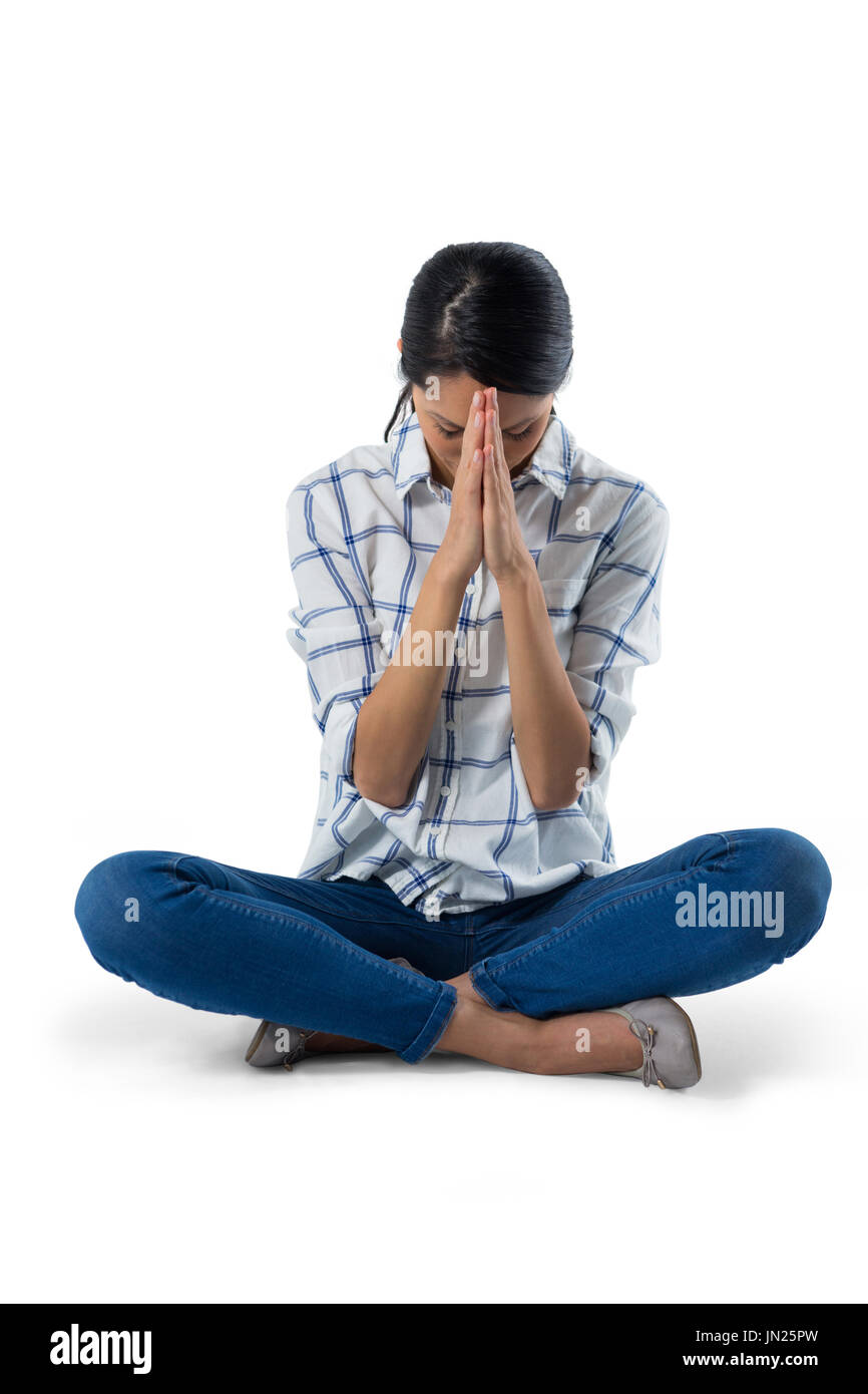 Beautiful woman praying against white background Stock Photo - Alamy