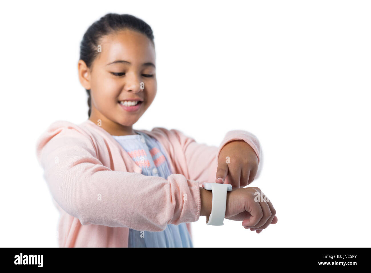 Smiling girl operating her smart watch against white background Stock ...