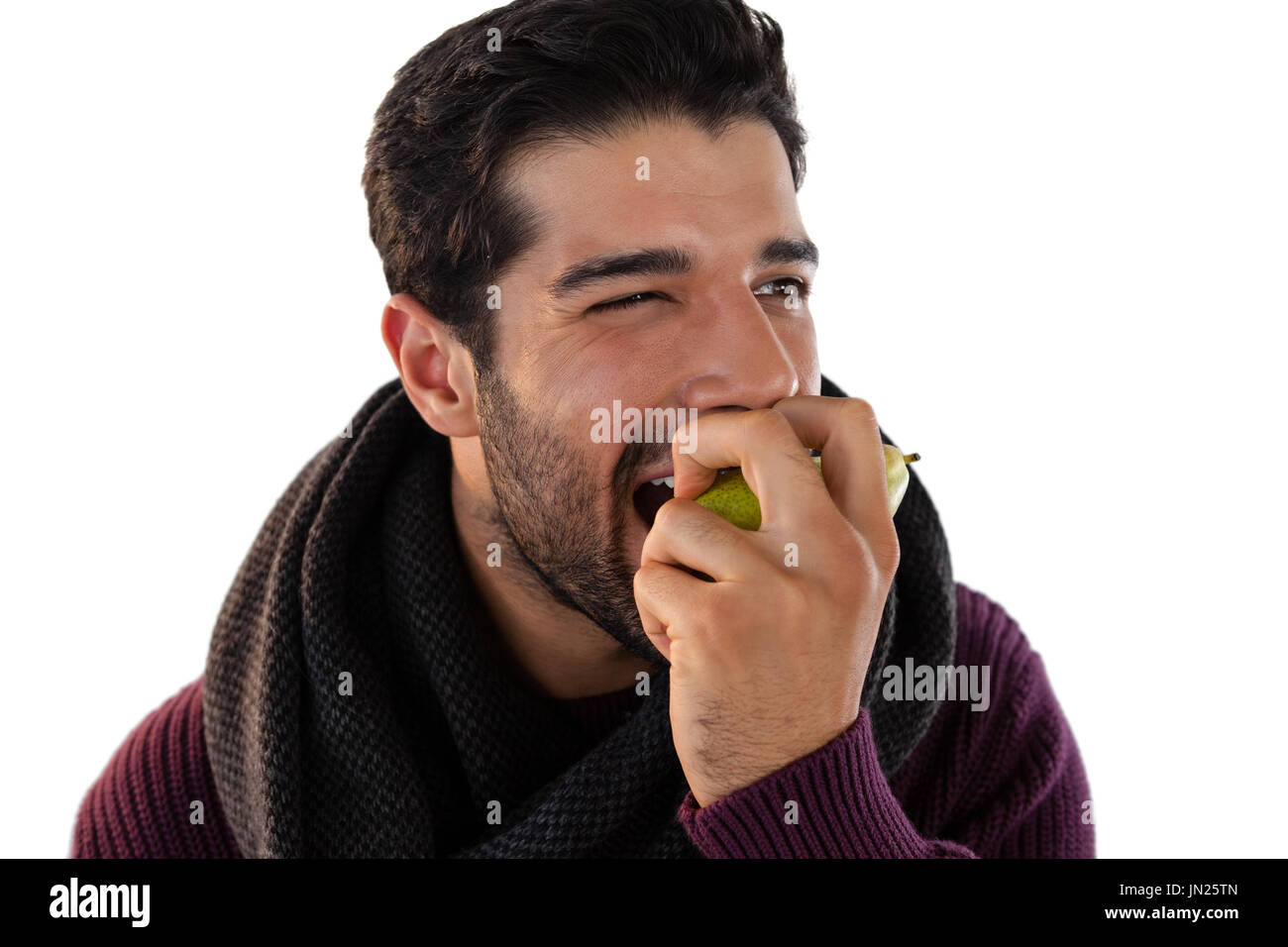 Close-up of man eating pears against white background Stock Photo - Alamy