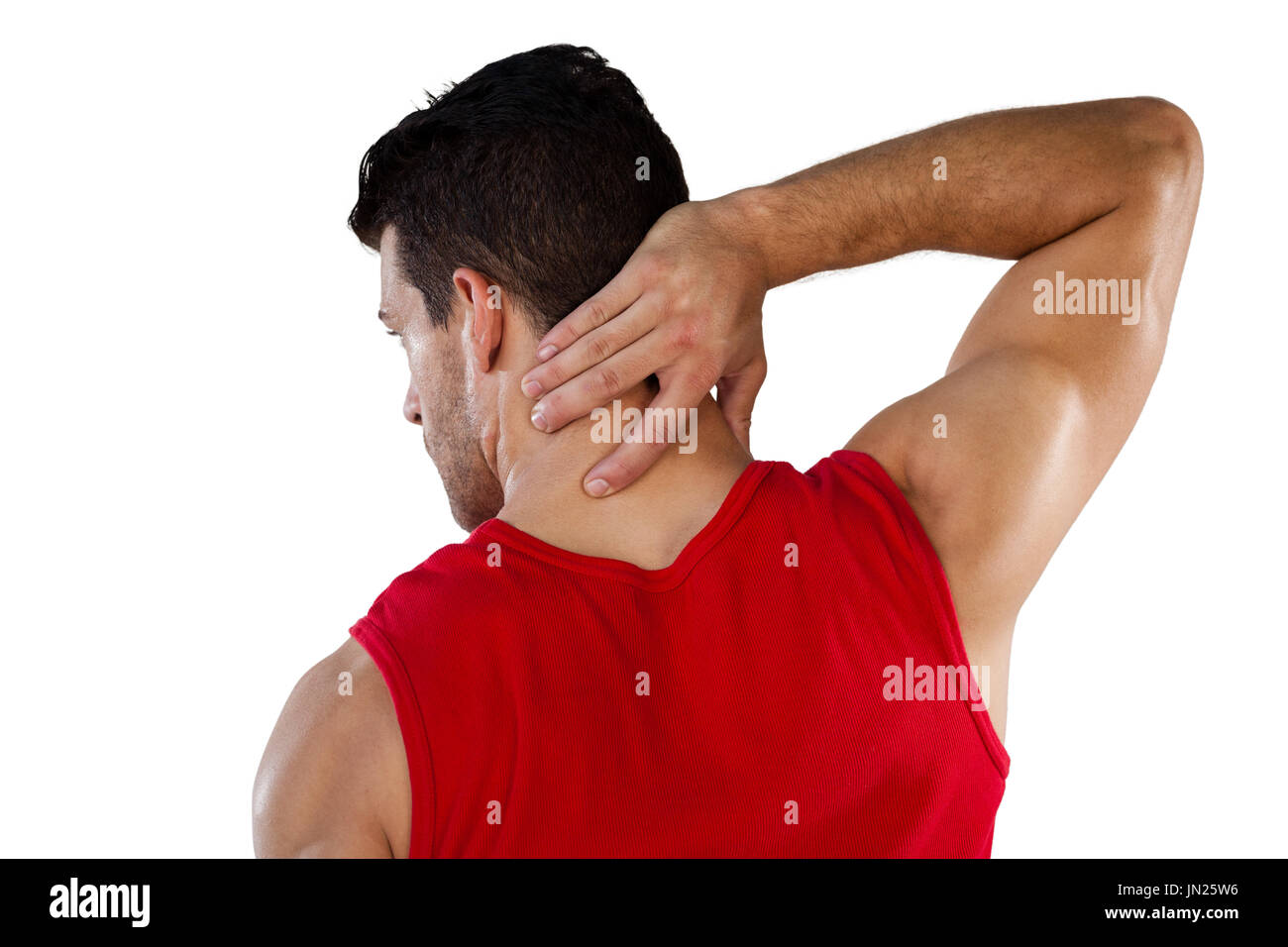 Rear view of American football player suffering from neck pain while ...