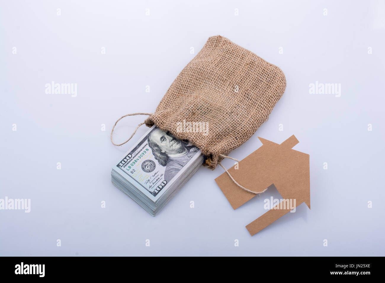 Paper house placed beside a bundle of US dollar banknote Stock Photo ...