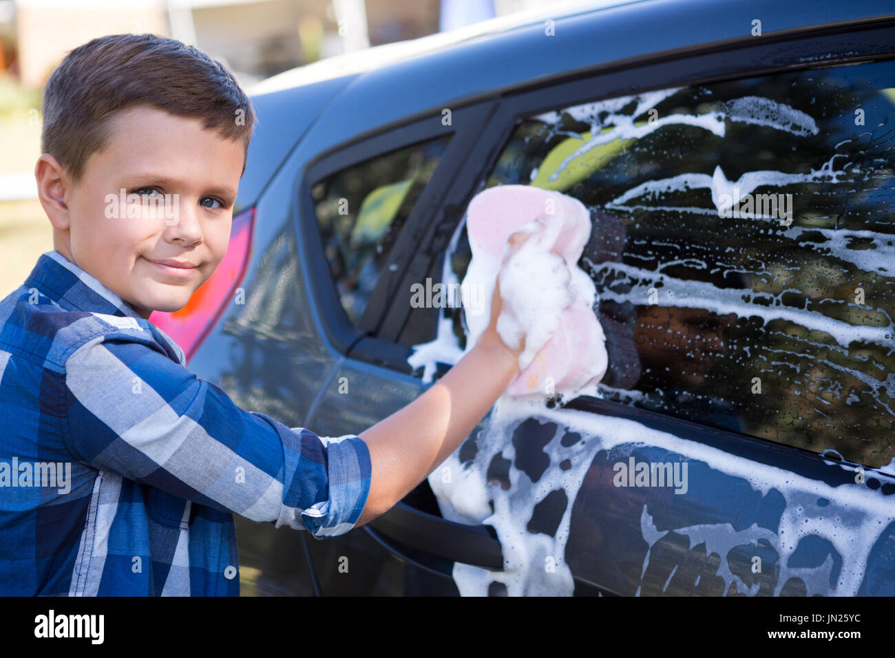 Teenage boy washing car hi-res stock photography and images - Alamy
