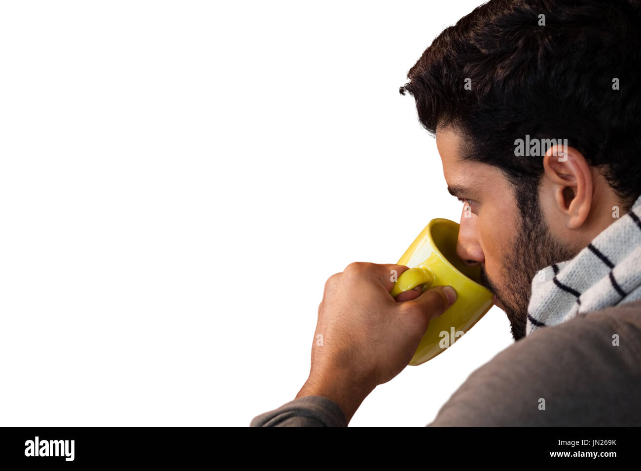 Thoughtful man having a mug of coffee against white background Stock ...