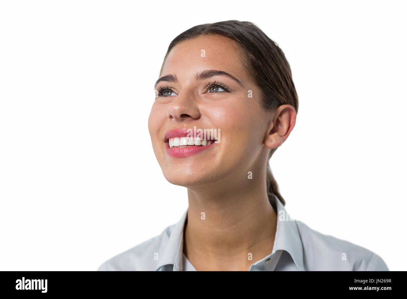 Beautiful female executive smiling against white background Stock Photo ...