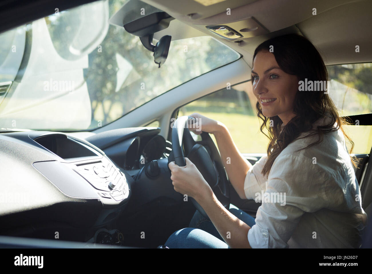 Smiling woman driving car hi-res stock photography and images - Alamy