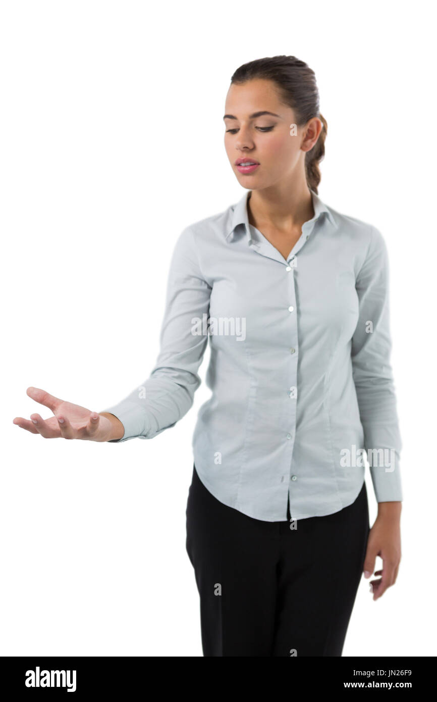 Female executive holding invisible object against white background ...
