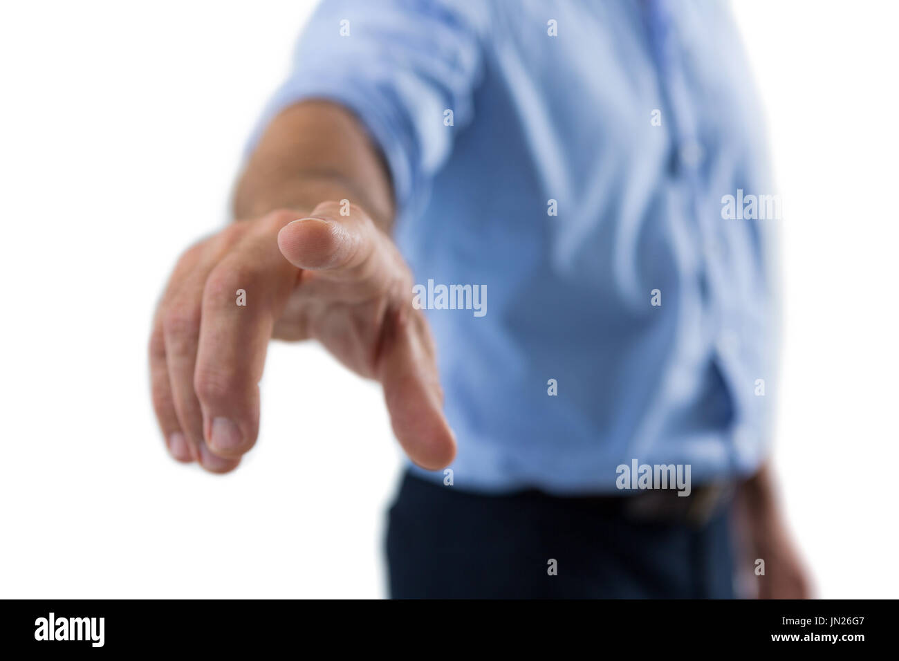 Mid section of male executive pressing an invisible virtual screen ...