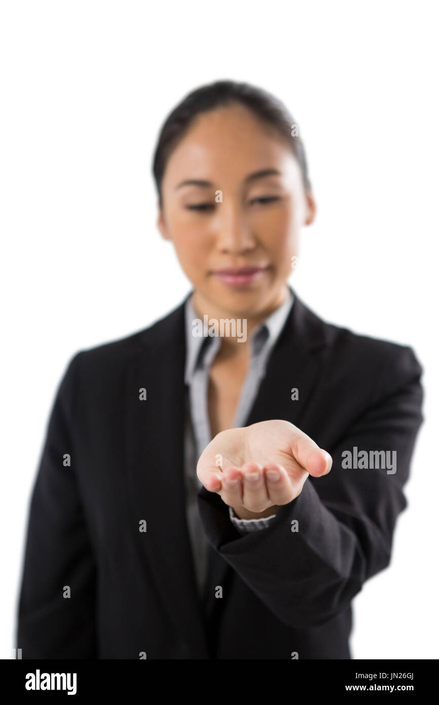 Female executive holding invisible object against white background ...