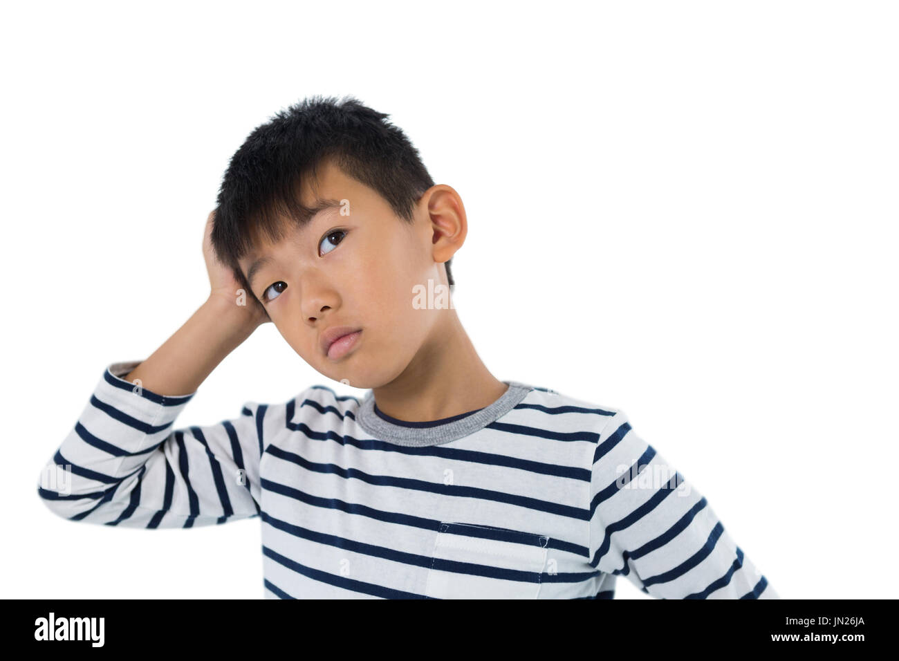 Thoughtful boy standing against white background Stock Photo - Alamy