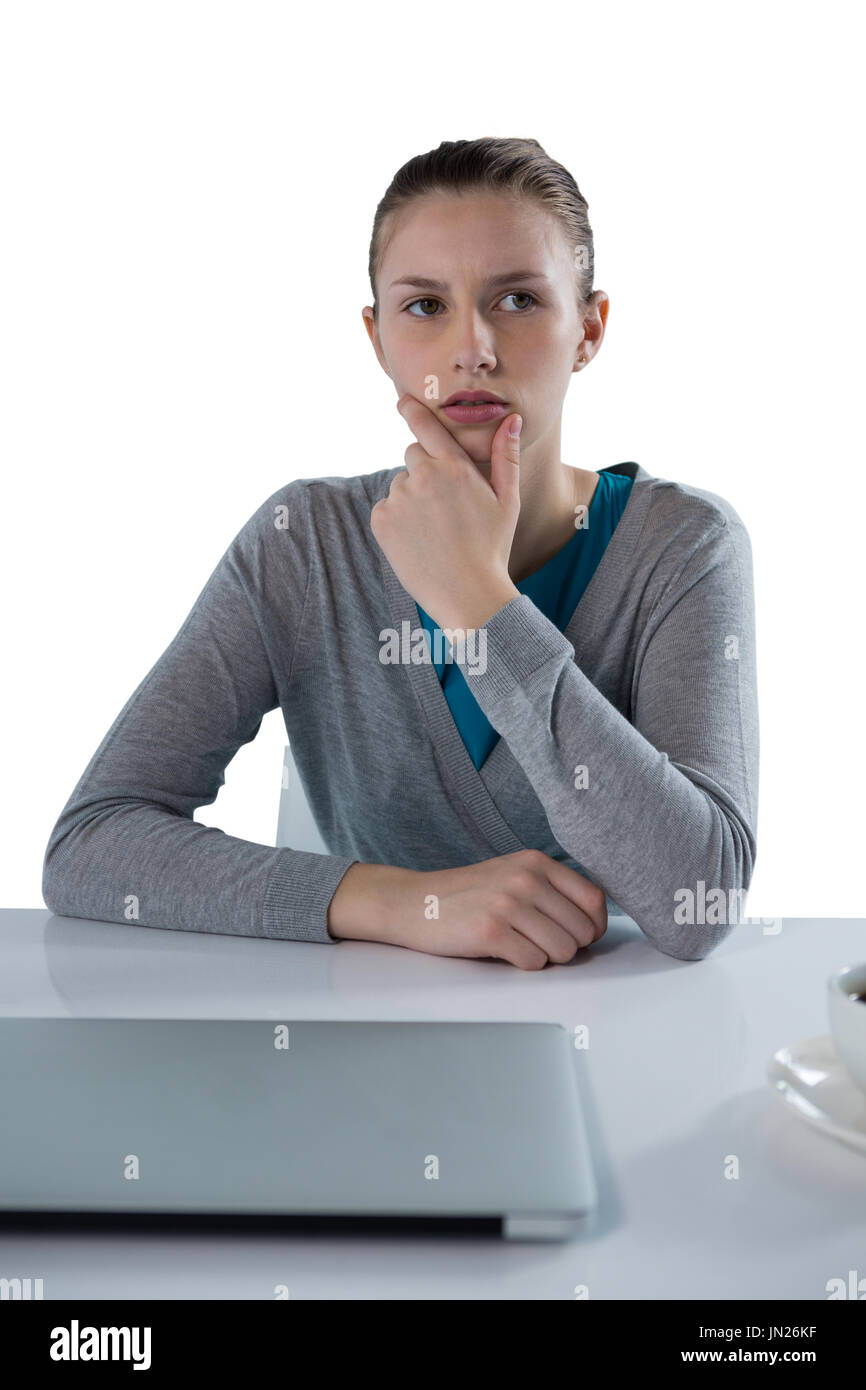 Thoughtful teenage girl using laptop against white background Stock ...