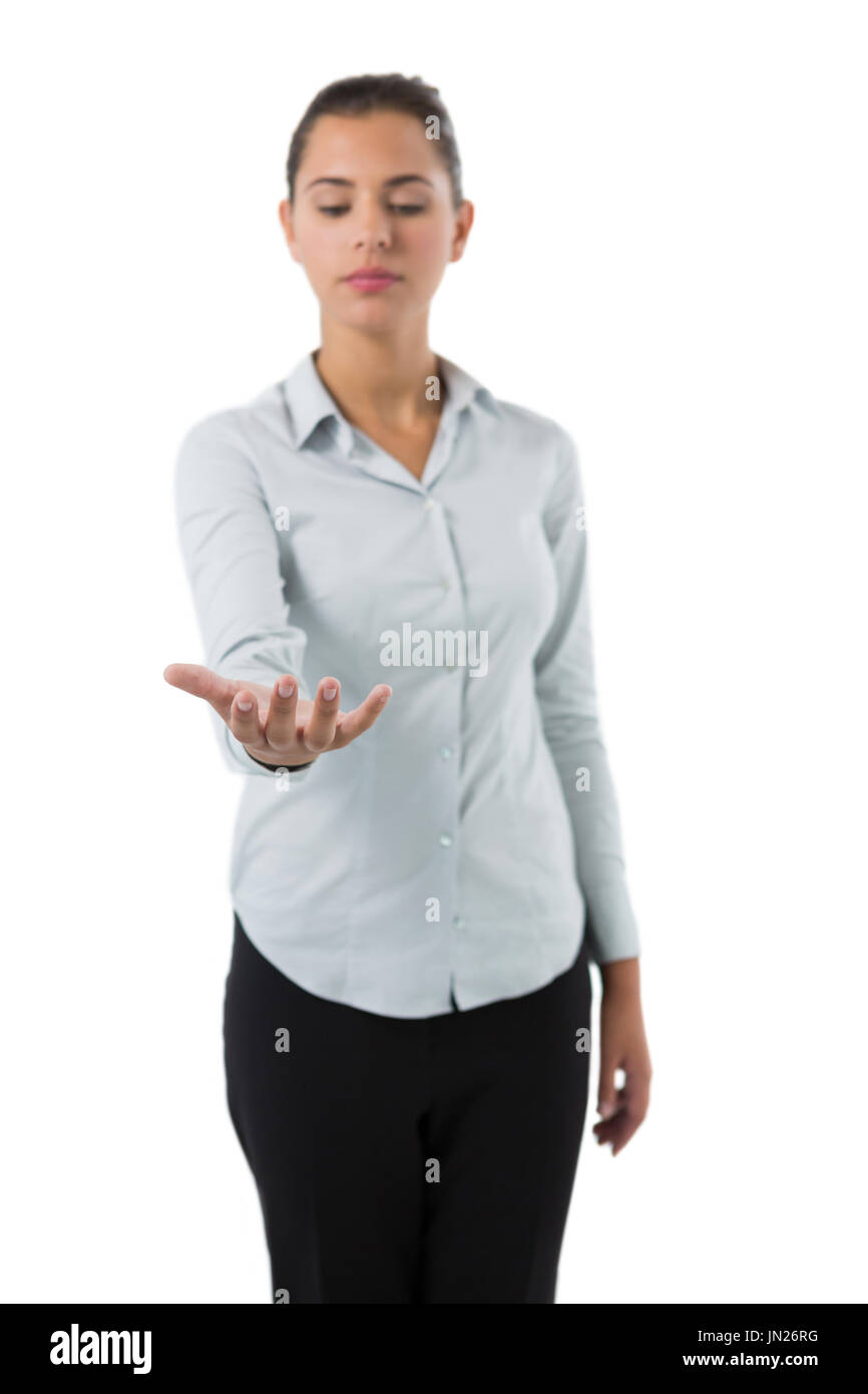 Female executive holding invisible object against white background ...