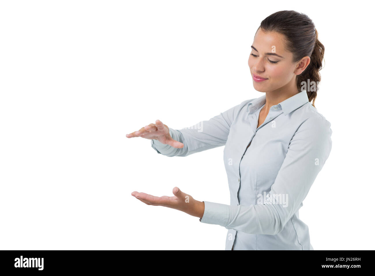 Female executive holding invisible object against white background ...