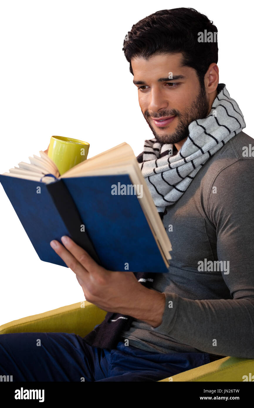 Man reading book while having coffee against white background Stock ...