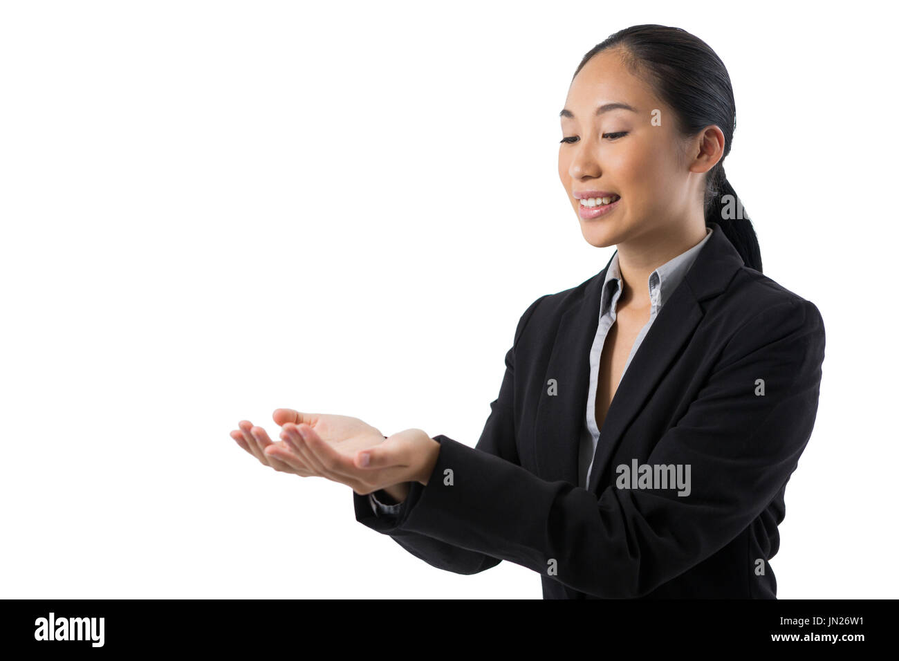 Businesswoman holding invisible object against white background Stock ...
