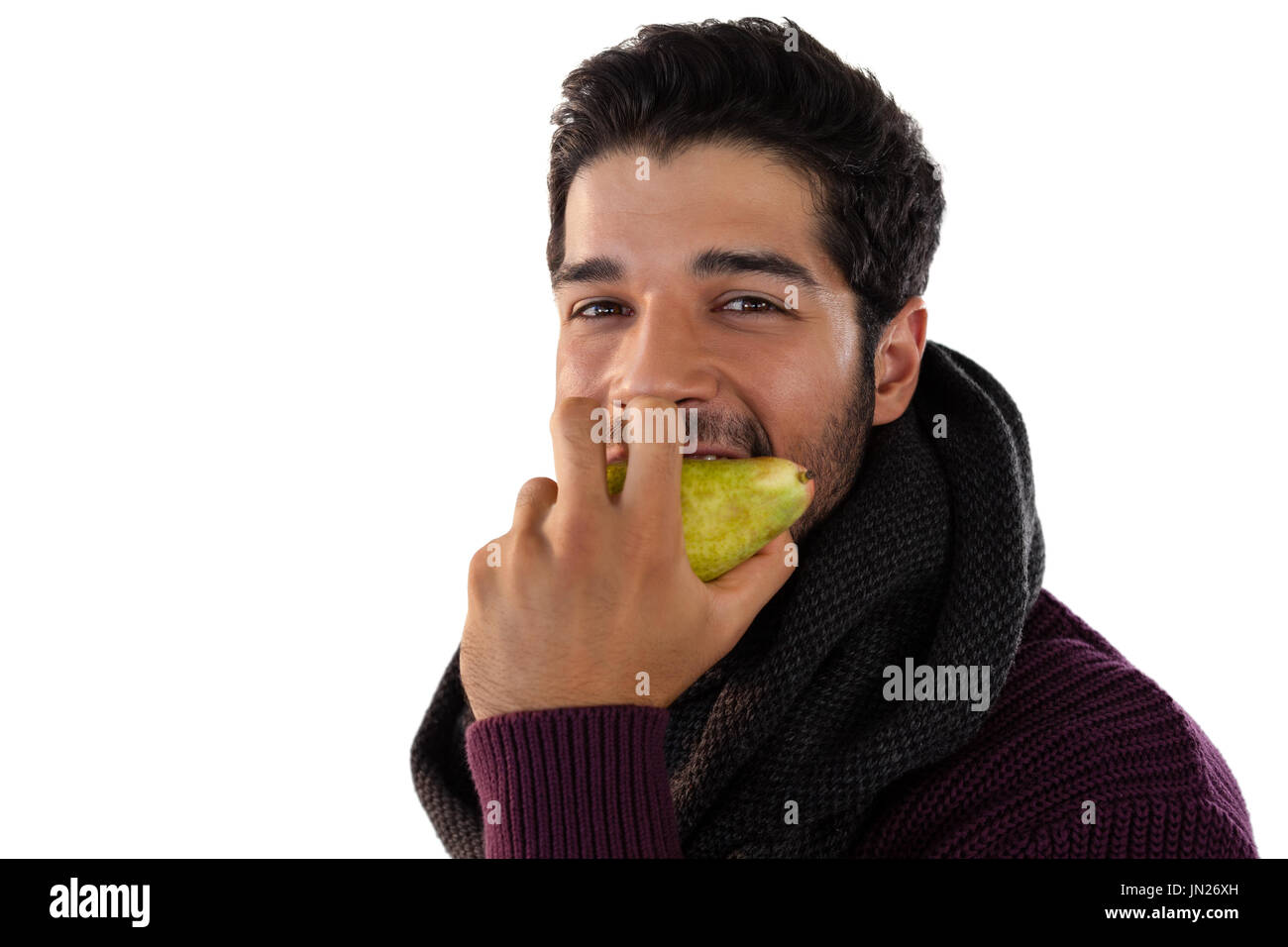 Portrait of smiling man eating pears against white background Stock ...