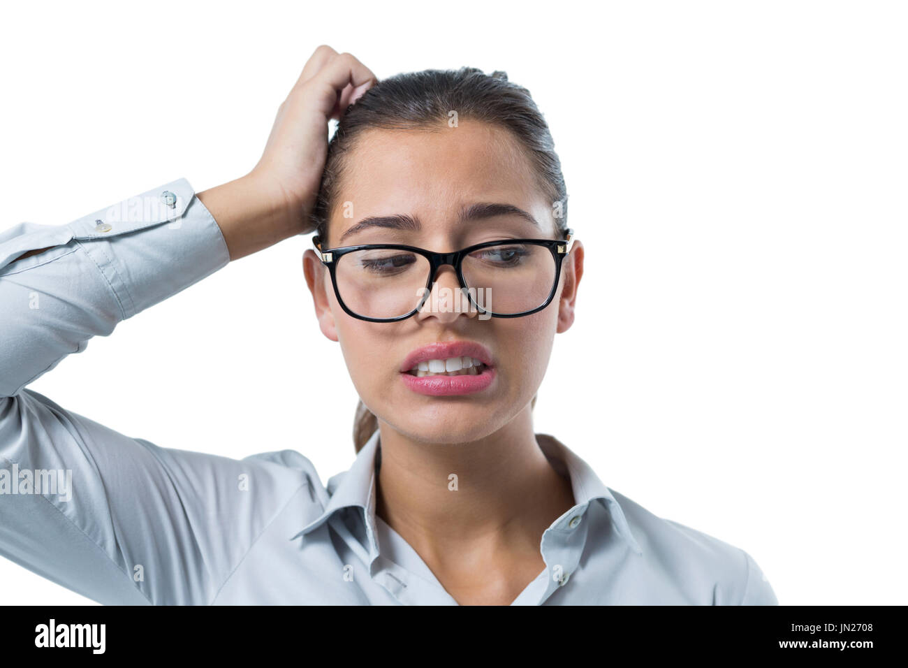Confused female executive standing against white background Stock Photo ...