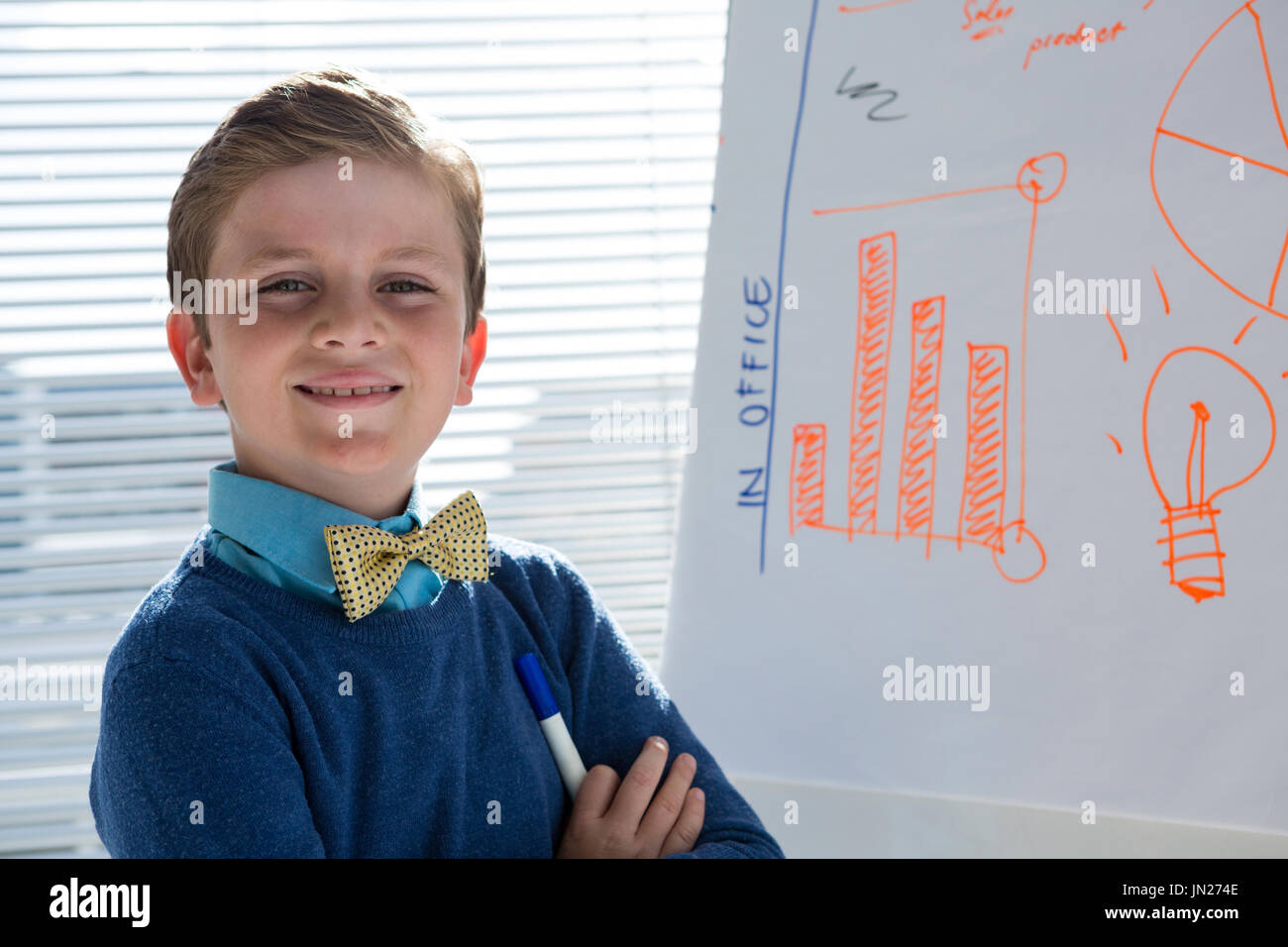Boy as business executive presenting on white board in office Stock ...