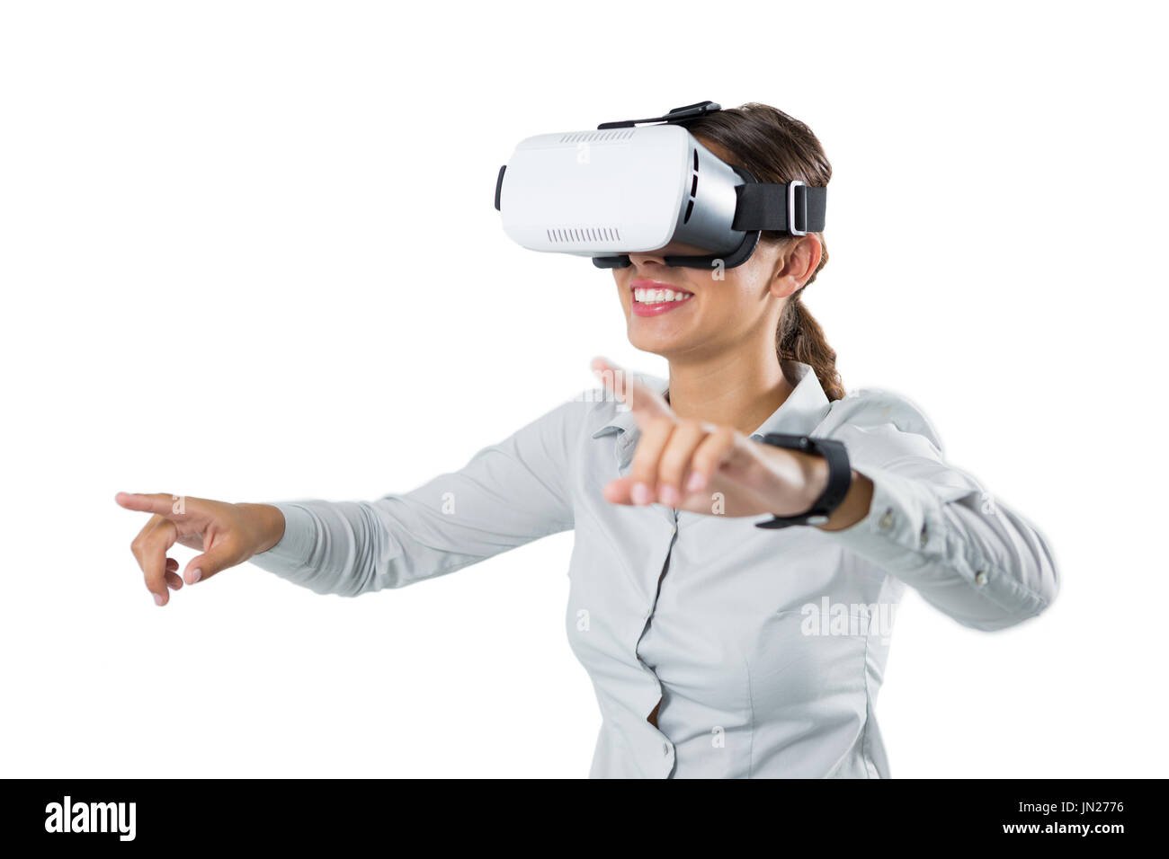 Female executive using virtual reality headset against white background ...