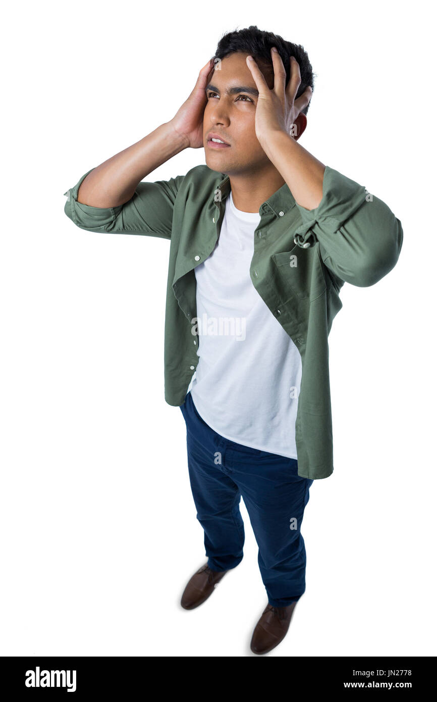 Tensed man with hands on head standing on white background Stock Photo ...