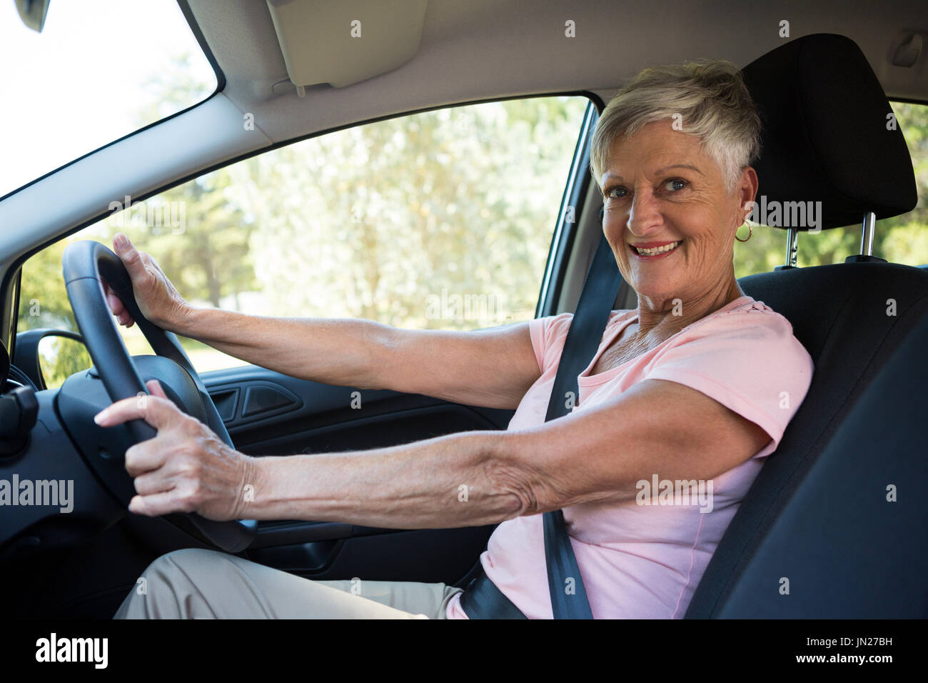 Portrait of active senior woman driving a car Stock Photo - Alamy