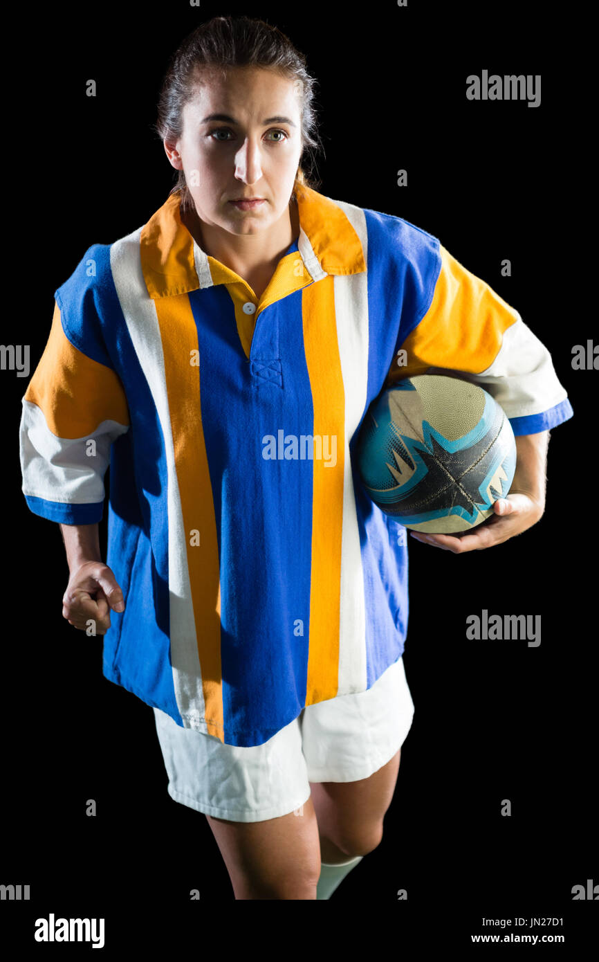 Young female athlete playing rugby against black background Stock Photo ...