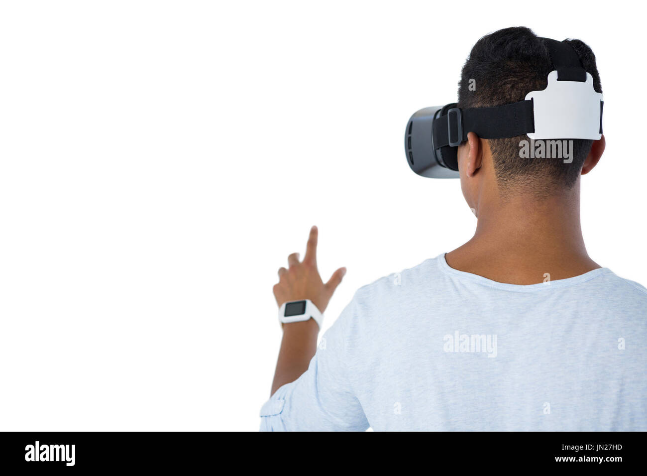 Rear view of man using virtual reality headset against white background ...