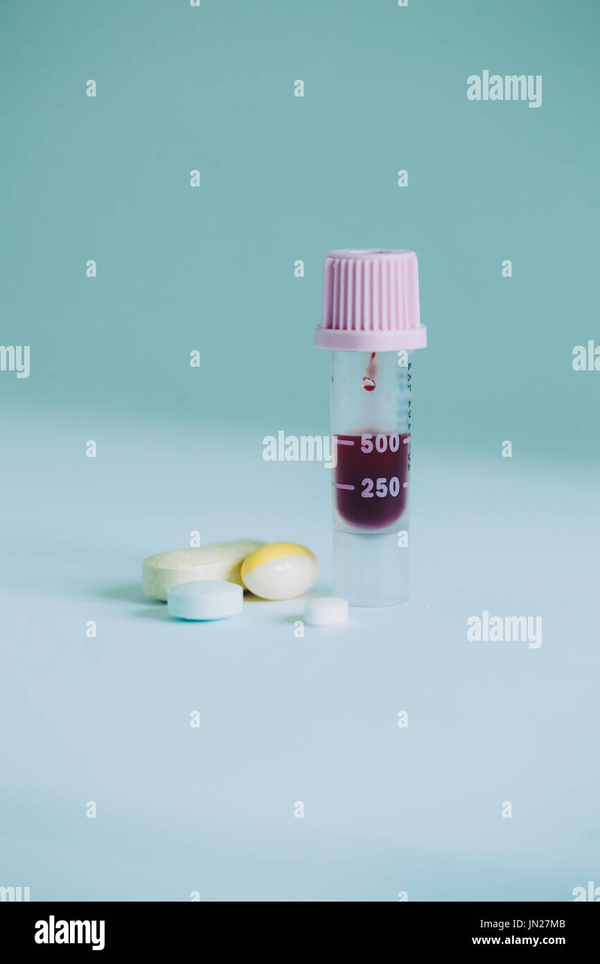 A vial of blood with medicine tablets and pills Stock Photo - Alamy