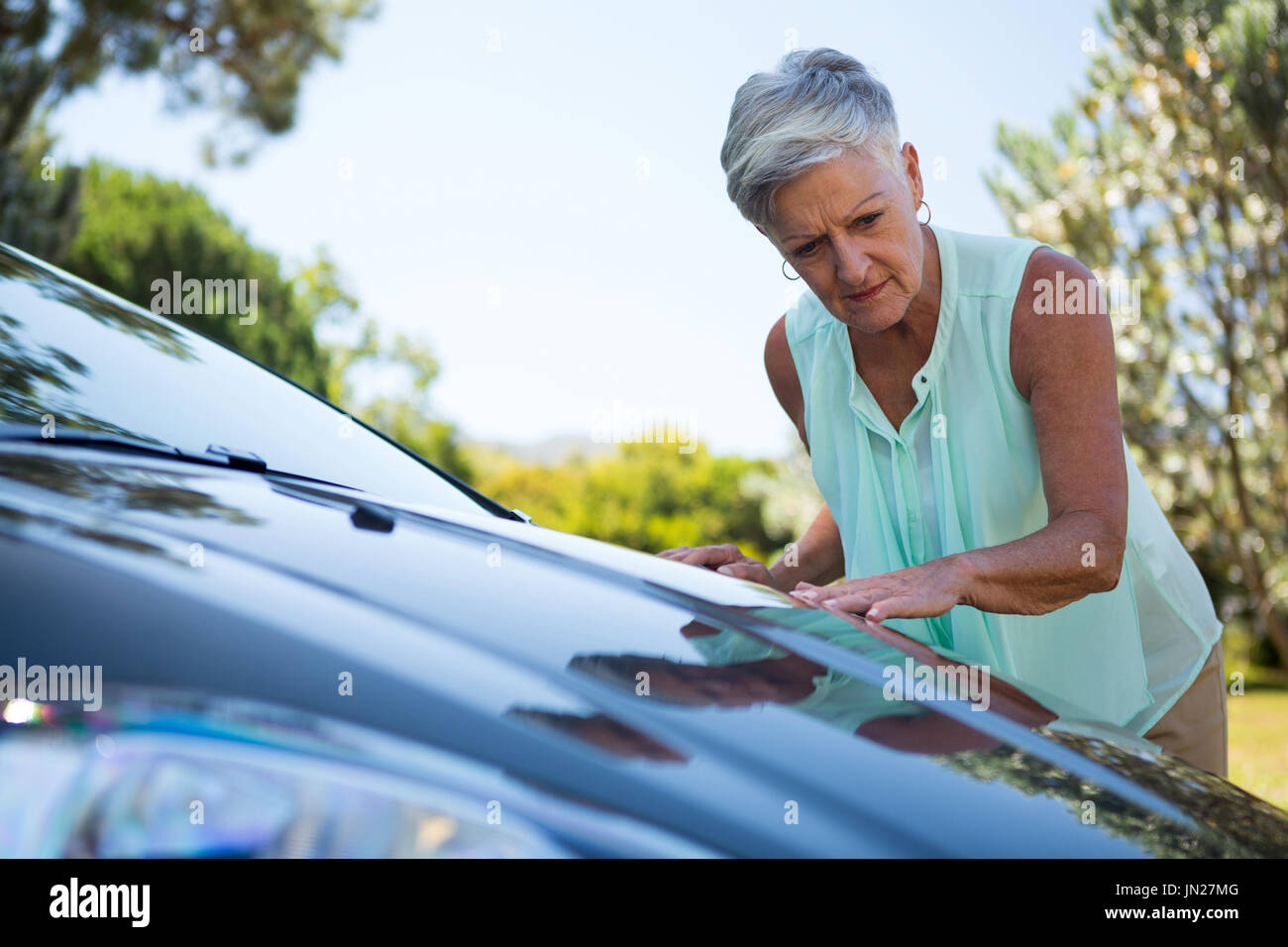 Woman standing car checking hi-res stock photography and images - Alamy