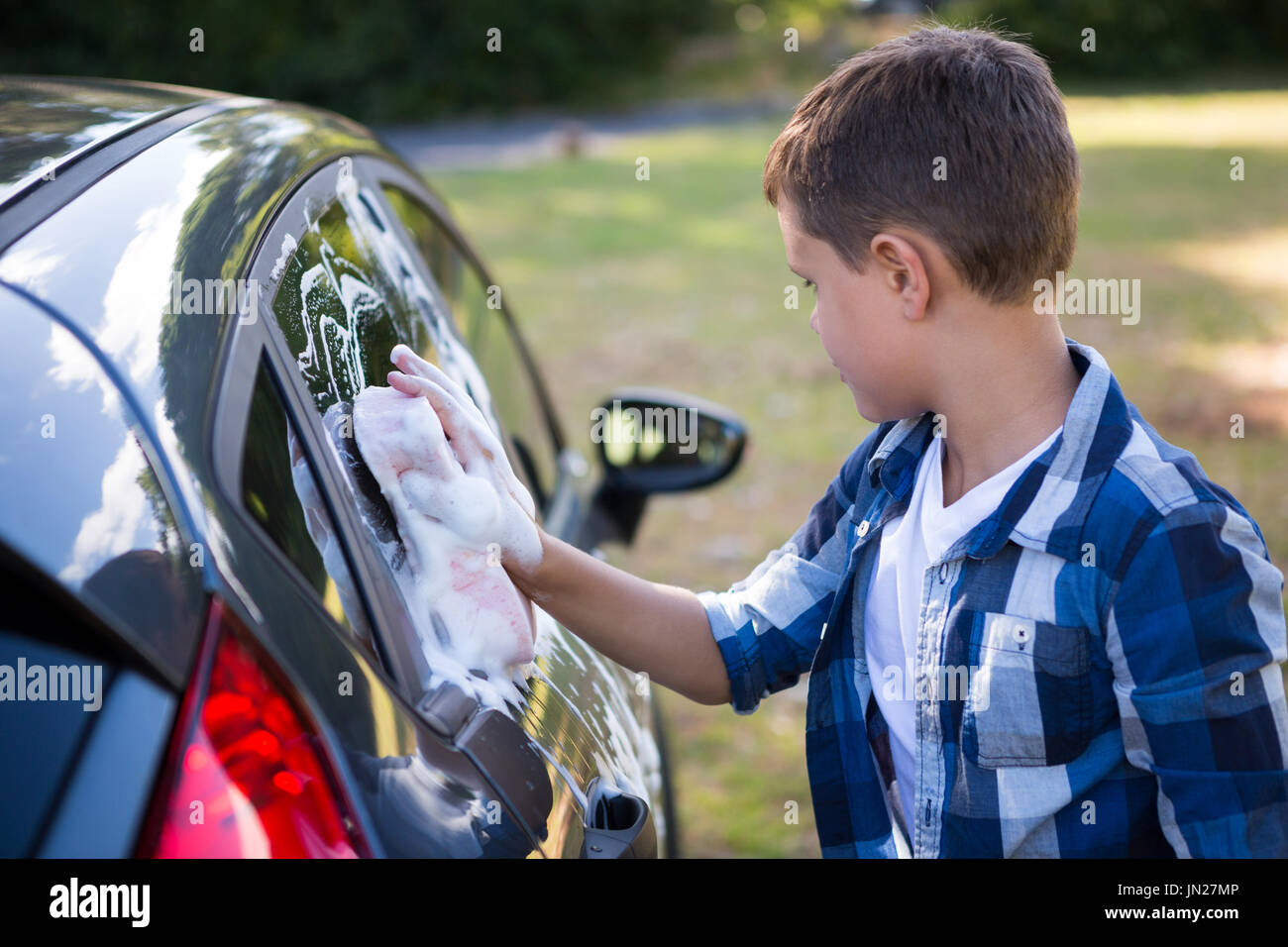 Teenage boy washing car hi-res stock photography and images - Alamy