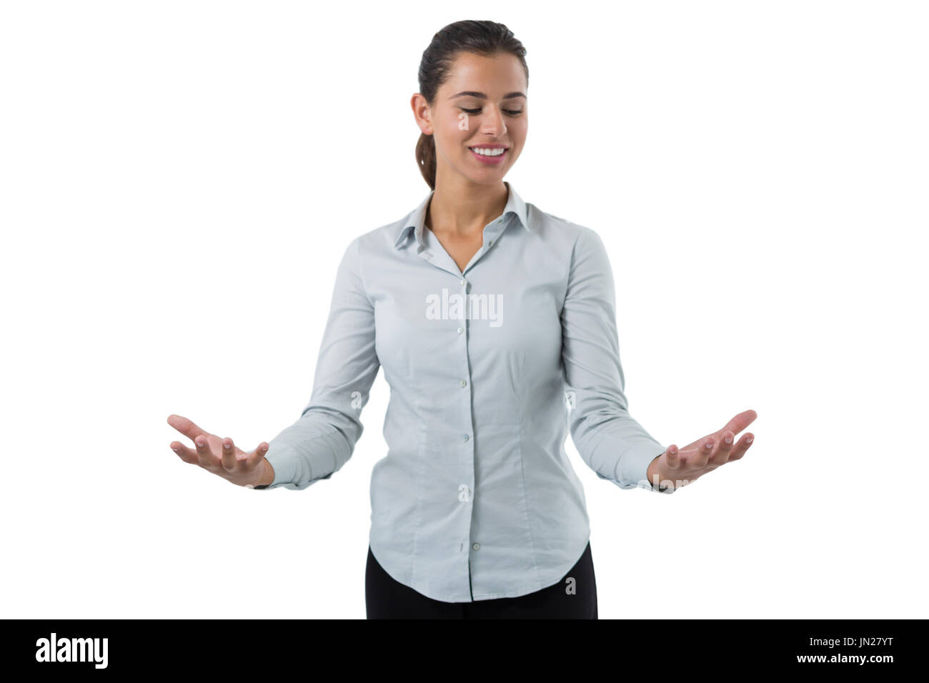 Female executive holding invisible object against white background ...