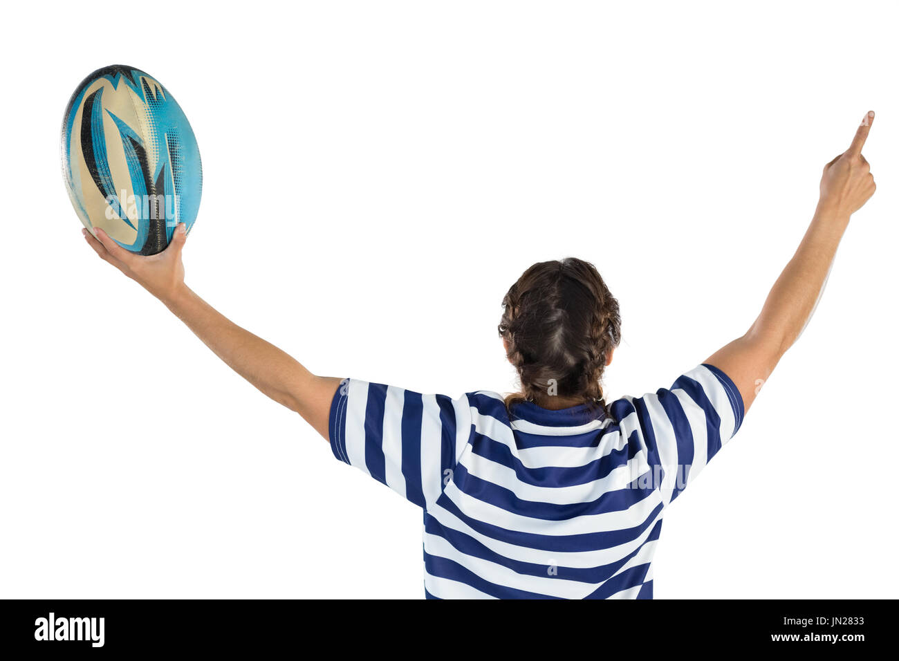 Rear view of female rugby player with arms raised against white ...