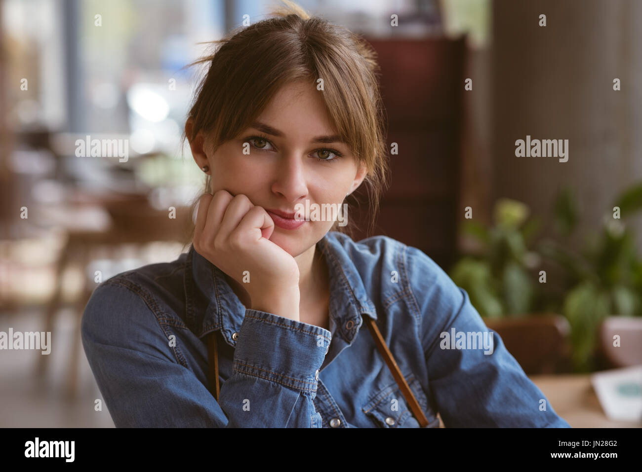 Beautiful waitress sitting in cafe Stock Photo - Alamy