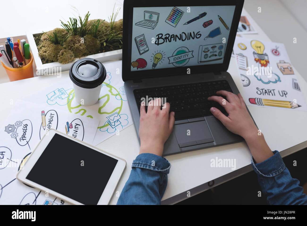 Mid-section of woman using laptop in the cafe Stock Photo - Alamy