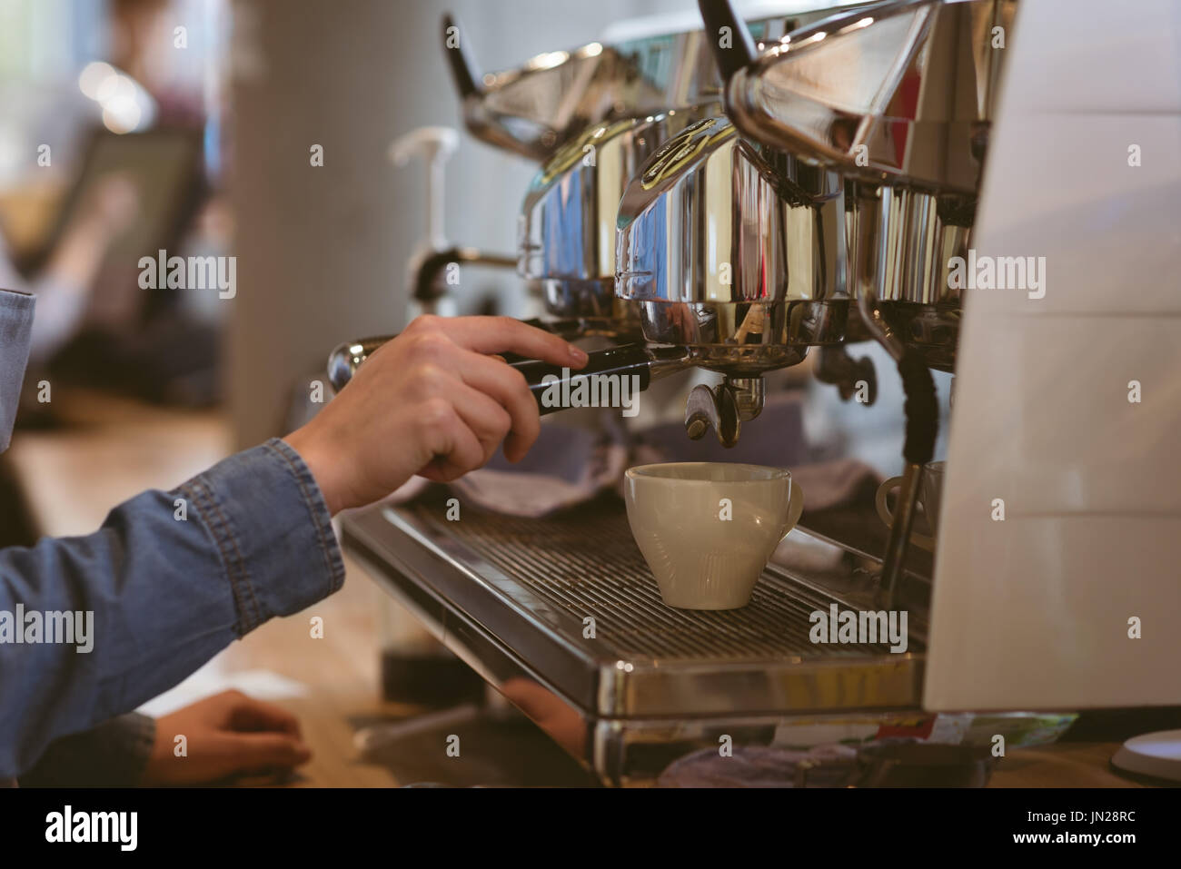 Waiter making cup of coffee at counter in kitchen at cafÃƒÂ© Stock ...