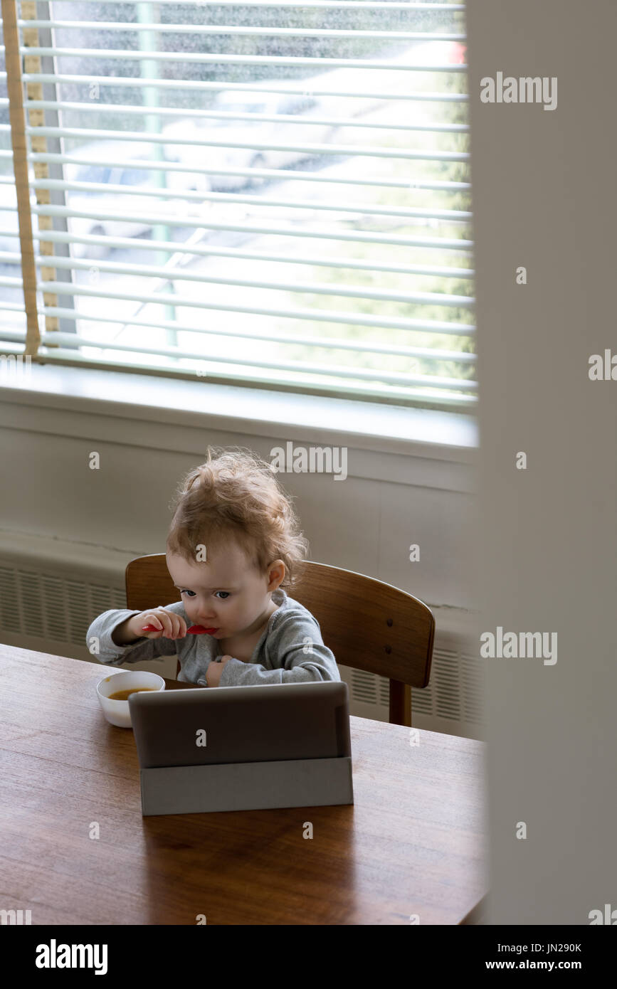 Child tablet table eating hi-res stock photography and images - Alamy