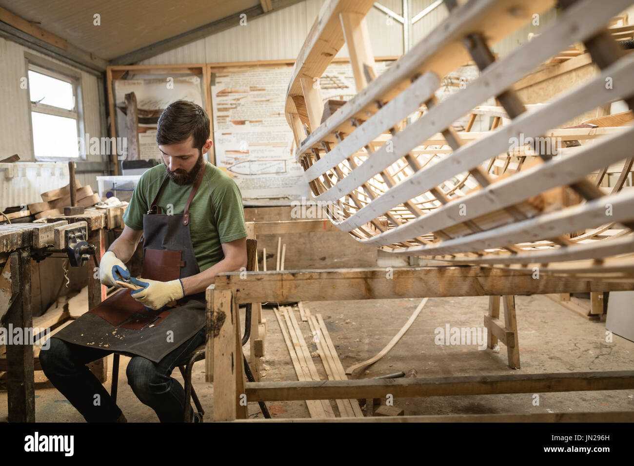 Attentive carpenter shaping wood in workshop Stock Photo - Alamy