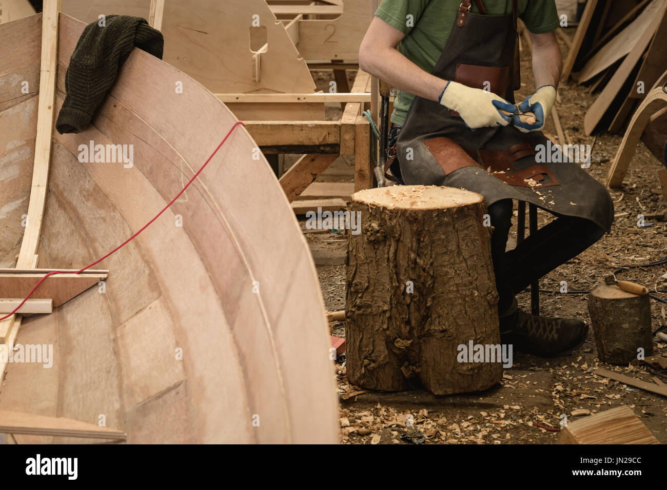 Low section of carpenter shaping wood in workshop Stock Photo - Alamy