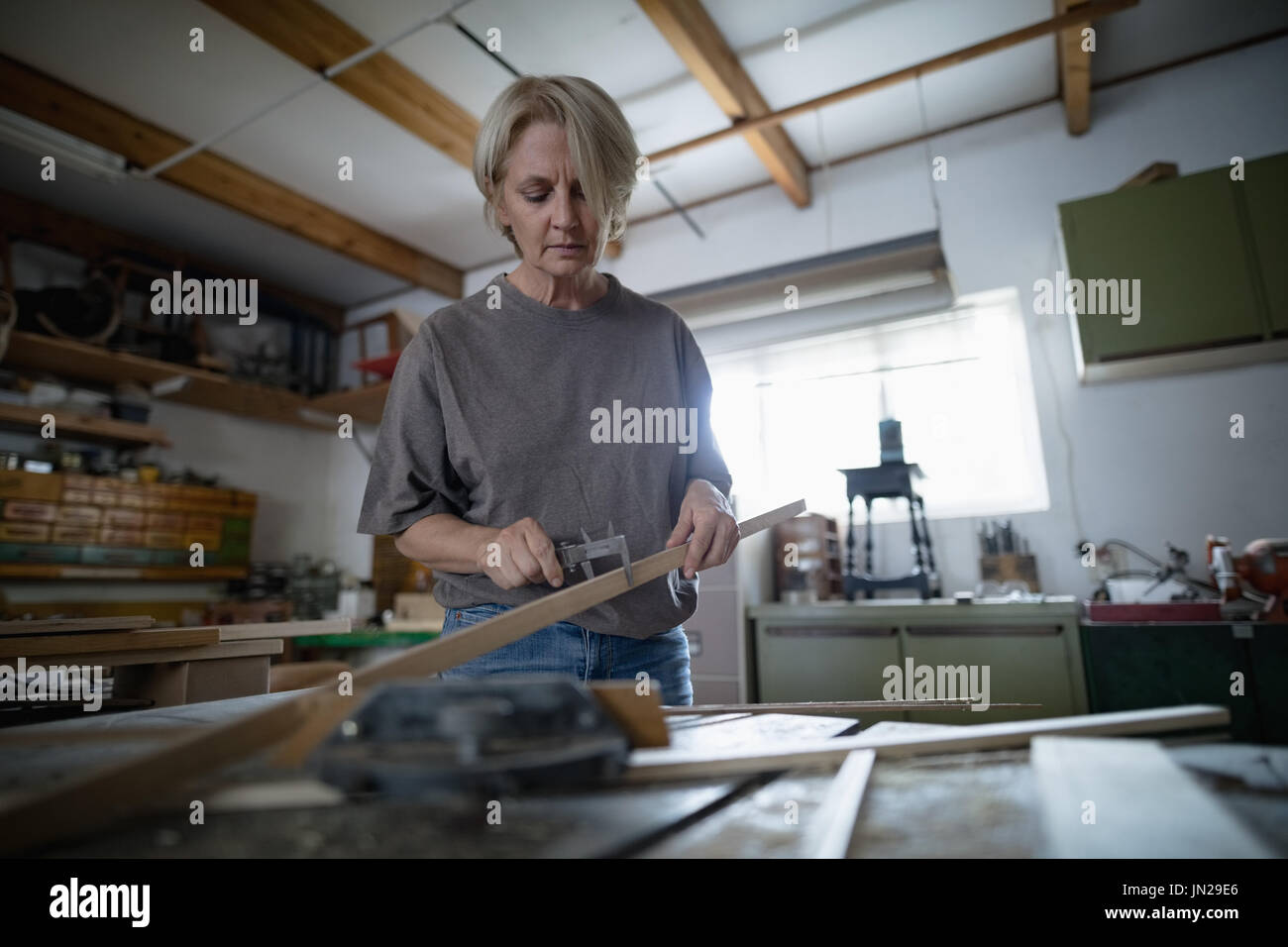 Senior woman doing carpentry work Stock Photo - Alamy