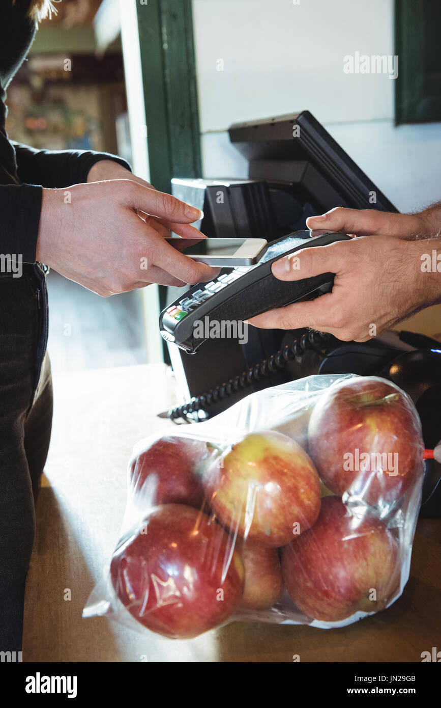 Woman paying grocery using hi-res stock photography and images - Alamy