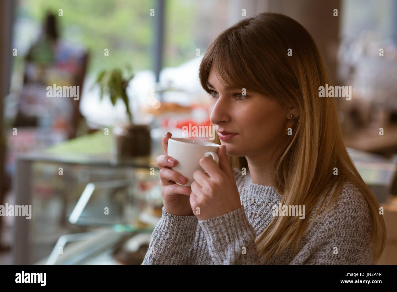 Beautiful woman having coffee in the cafe Stock Photo - Alamy
