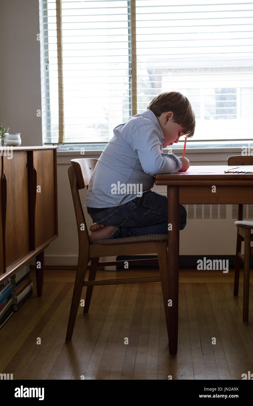 Boy drawing sitting on chair hi-res stock photography and images - Alamy