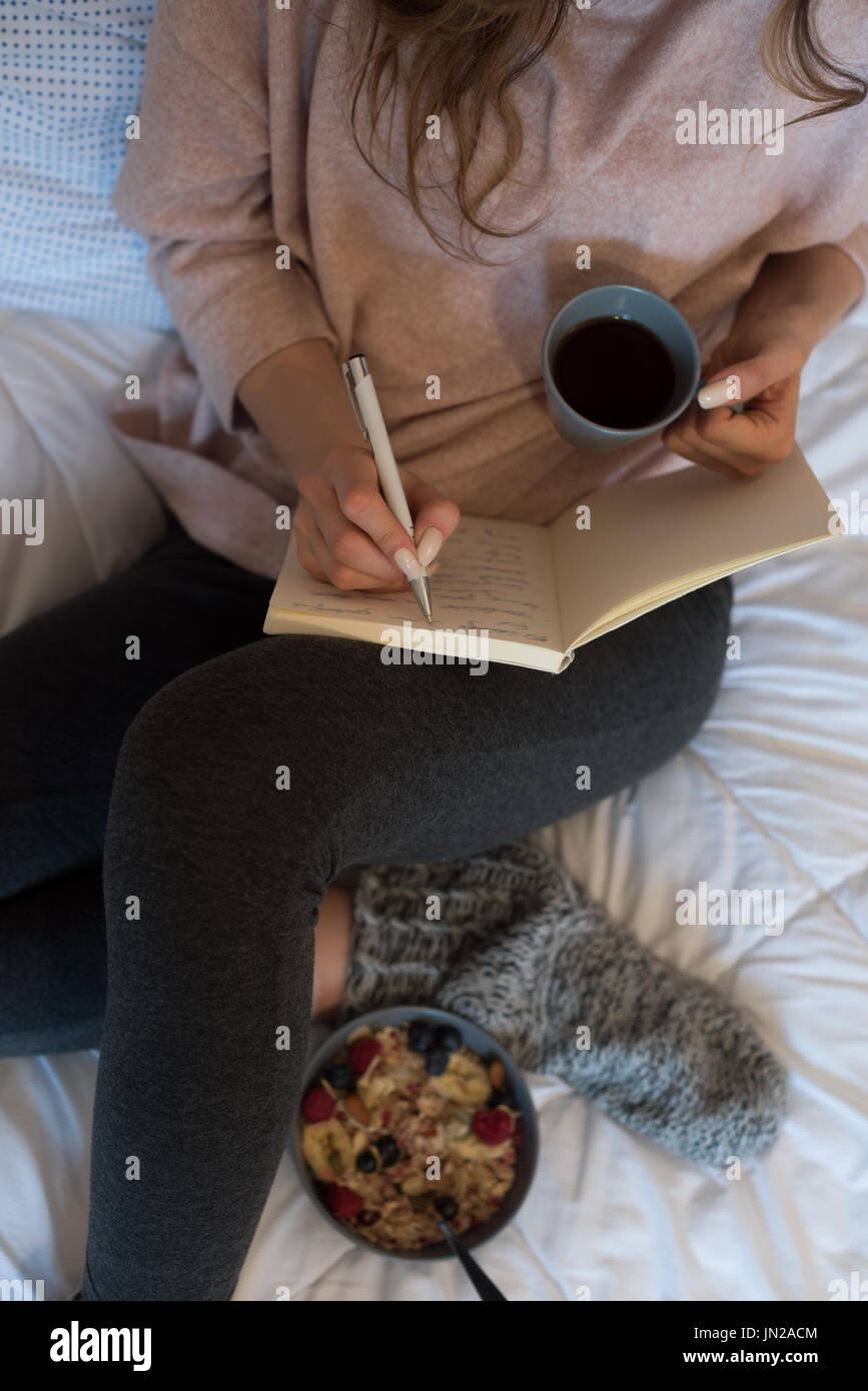 Woman writing diary bed hi-res stock photography and images - Alamy