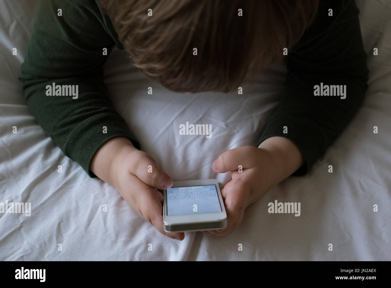 Boy bed phone hi-res stock photography and images - Alamy