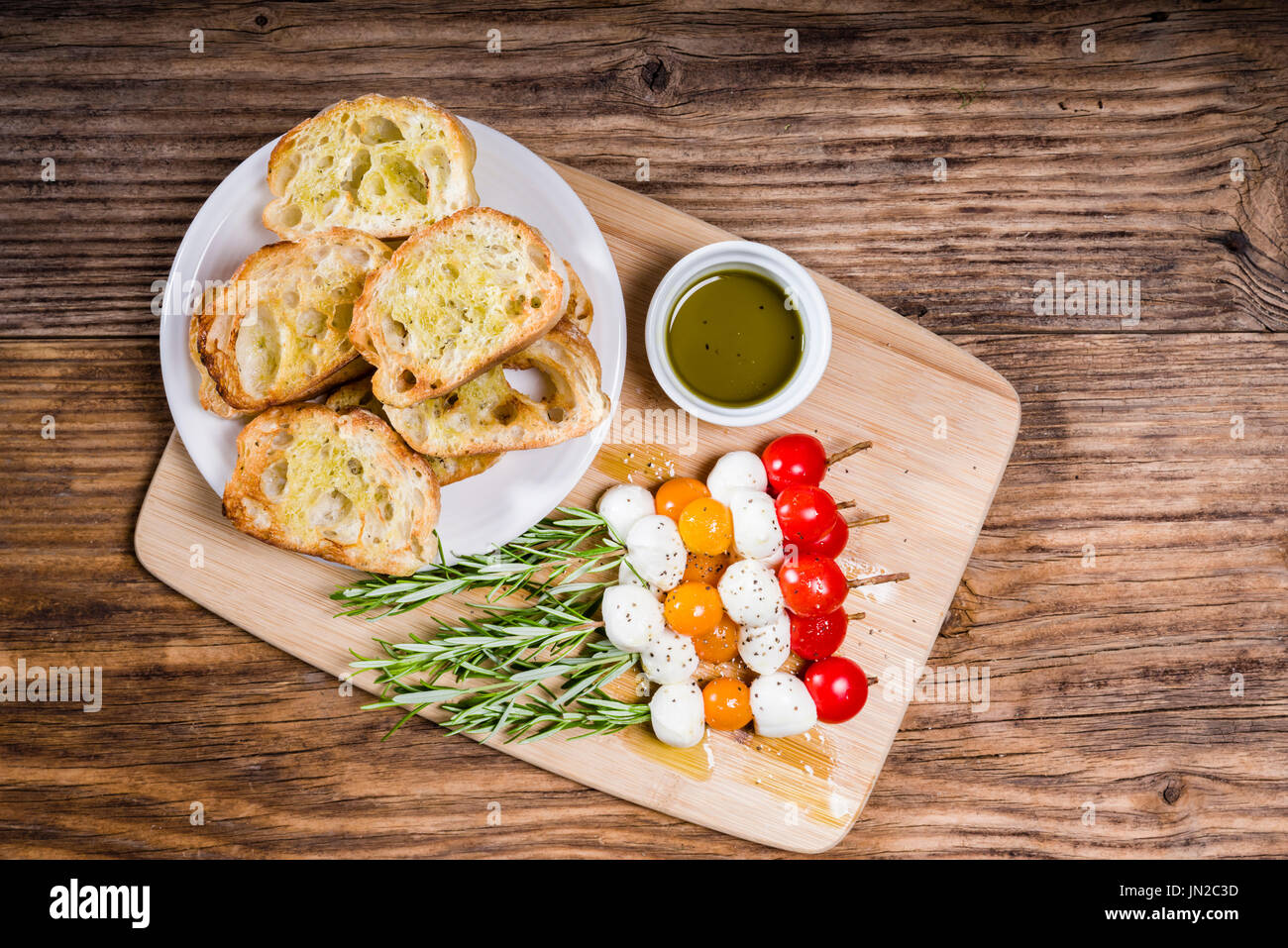 Tomato cheese and bread appetizers on rosemary skewers Stock Photo - Alamy