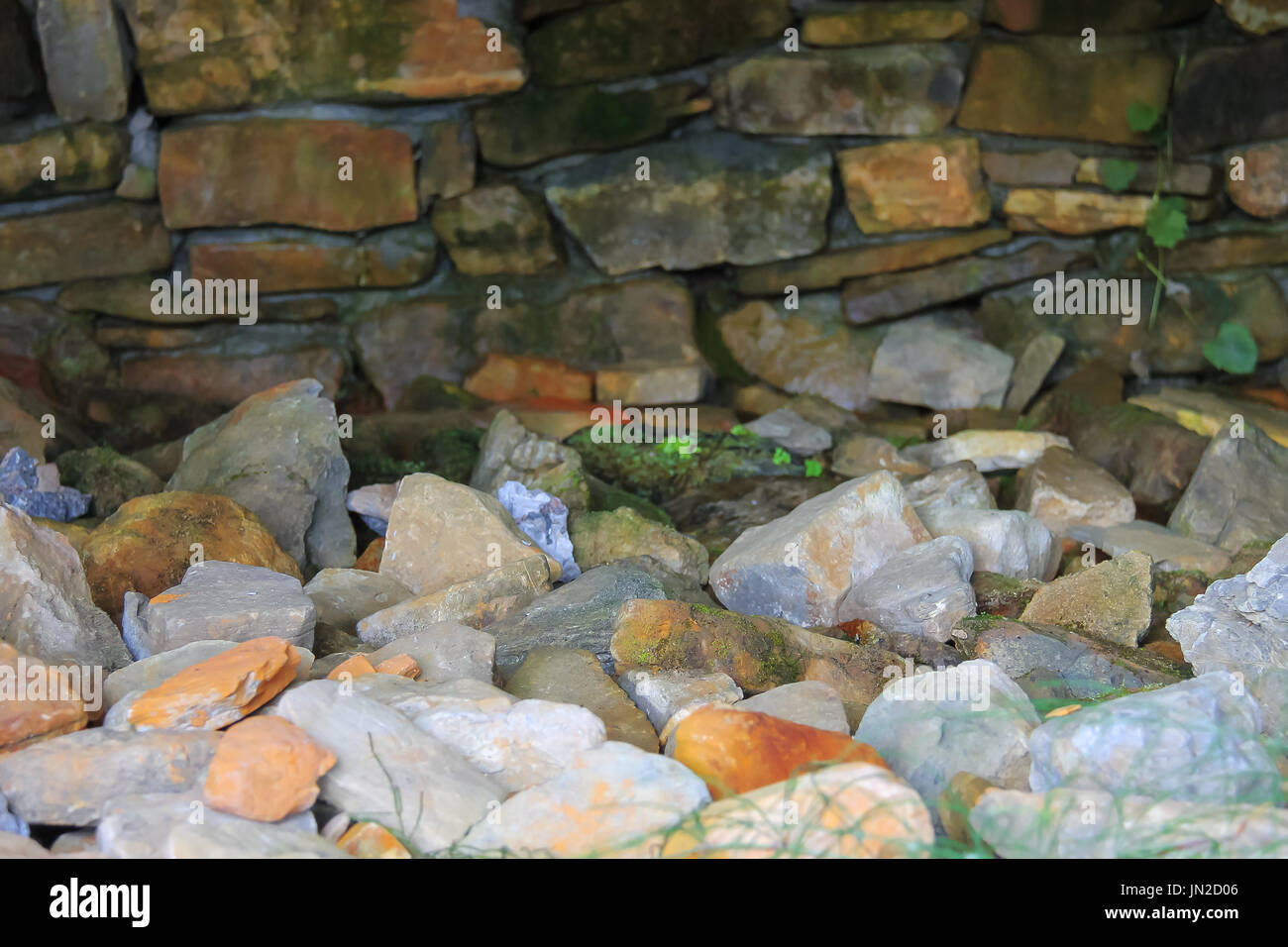 Stone wall and scattering of stones Stock Photo - Alamy