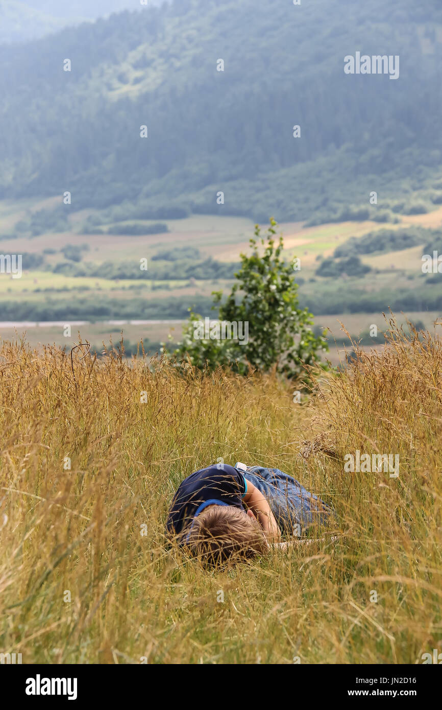 Handsome boy sleeping on meadow grass Stock Photo - Alamy