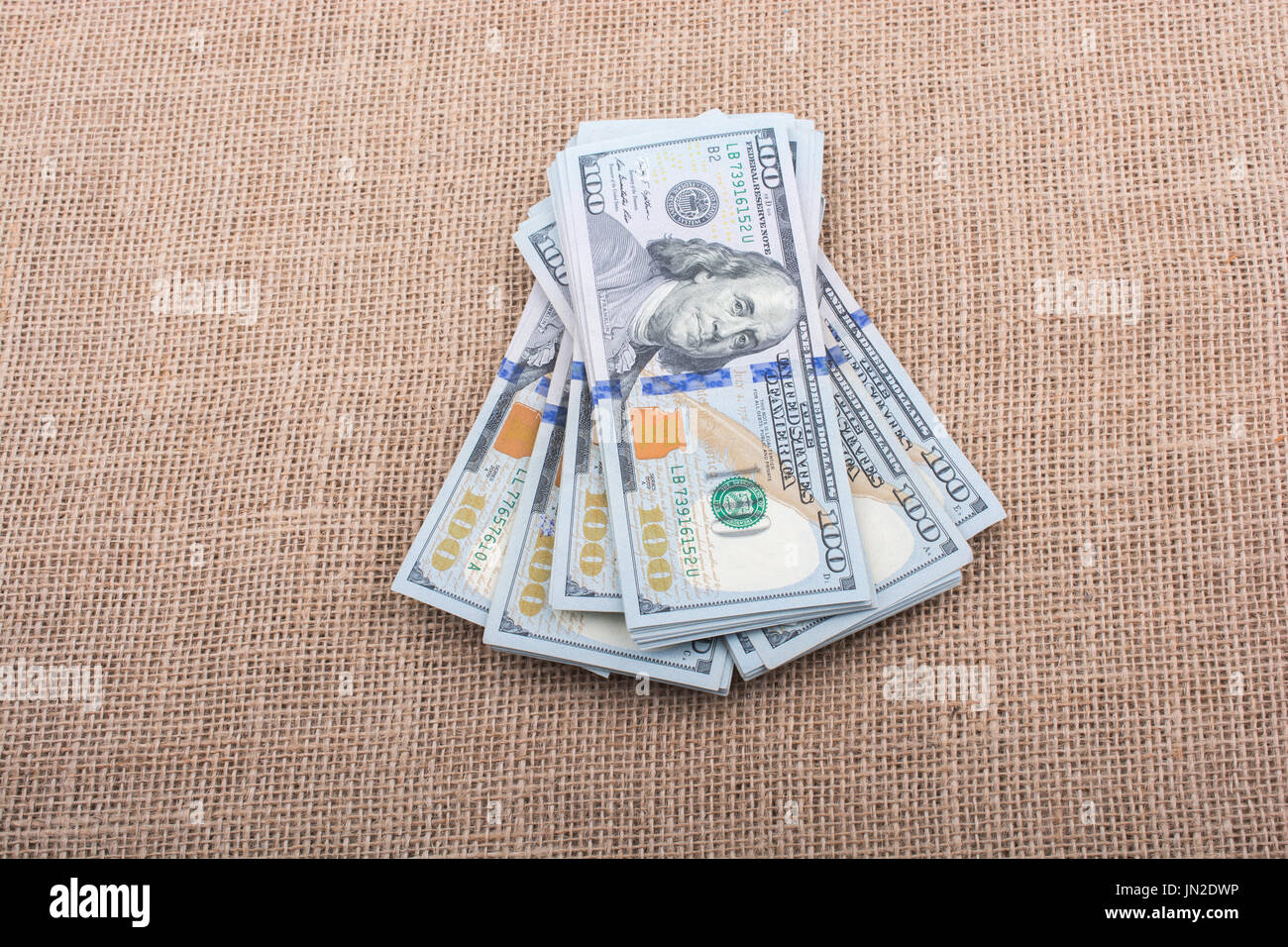 Banknote bundle of US dollar placed on a linen canvas Stock Photo - Alamy